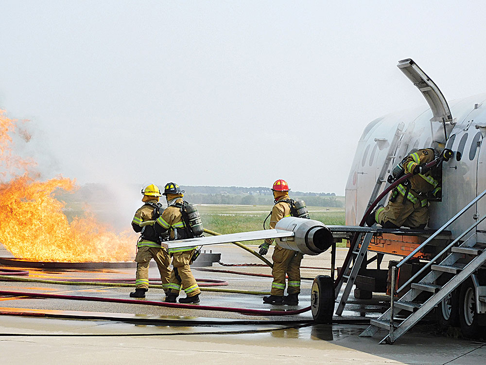 Minot firemen engage in simulated aircraft fire as part of training ...